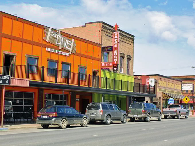 Sandpoint's colorful downtown looks like a movie set where small-town charm meets vibrant personality. The Dive restaurant adds a splash of orange to this picture-perfect scene.