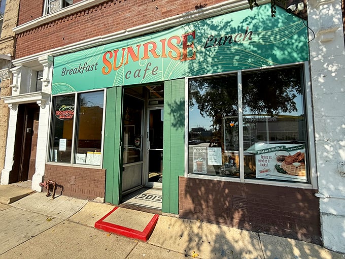 The cheerful green storefront of Sunrise Cafe beckons like an old friend. A breakfast sanctuary where pancake dreams come true!