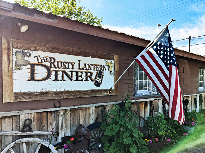 The Rusty Lantern beckons with its weathered charm. That American flag says "breakfast patriotism" like nothing else!