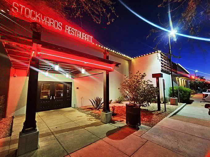 The Stockyards' iconic red neon sign glows like a beacon for steak lovers. Desert nights and sizzling beef &ndash; a match made in Arizona heaven!