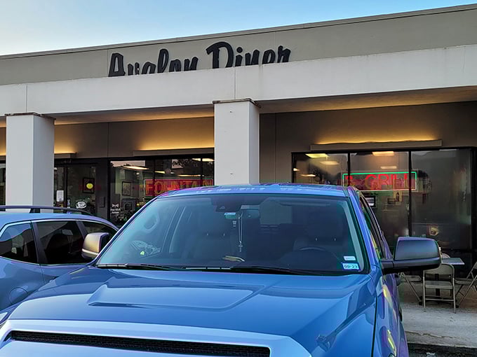 Cars line up outside Avalon Diner where "FOUNTAIN" glows in red neon - a promise of milkshakes that might follow your pancake feast.