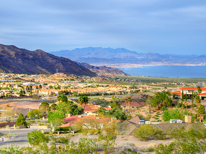 Where mountains meet suburbia! Boulder City's colorful homes pop against the dramatic backdrop of Nevada's rugged peaks.