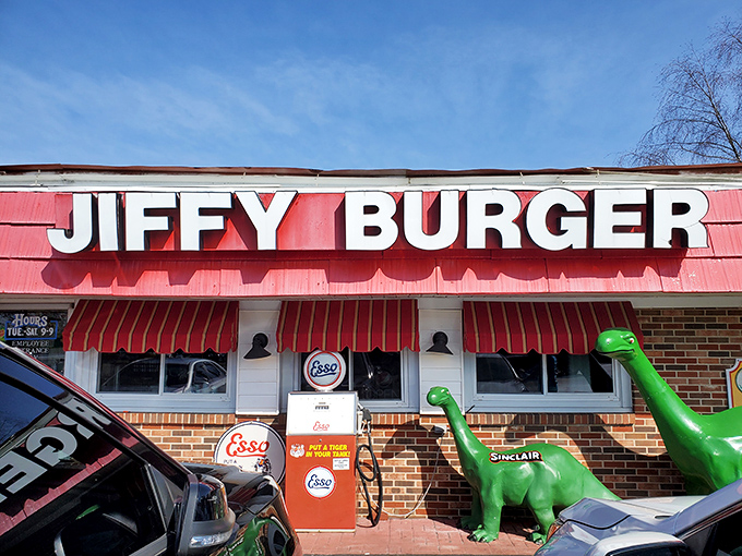 The retro charm is real! Jiffy Burger's vintage gas pump and friendly dinosaur mascot welcome you to burger paradise.
