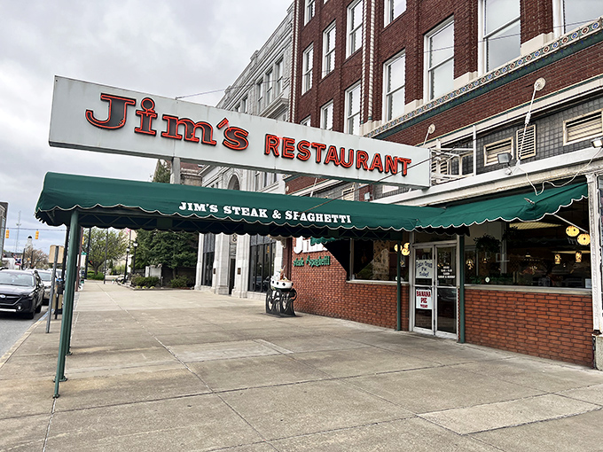 The classic green awning of Jim's Steak & Spaghetti House &ndash; where time stands still but the steaks keep coming.