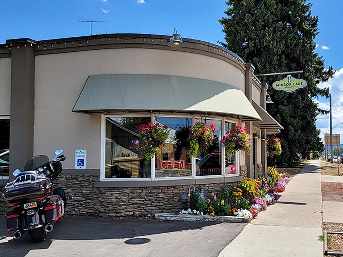 That neon "OPEN" sign is like a beacon of breakfast hope. Mirror Lake Diner promises pancakes worth pulling over for!