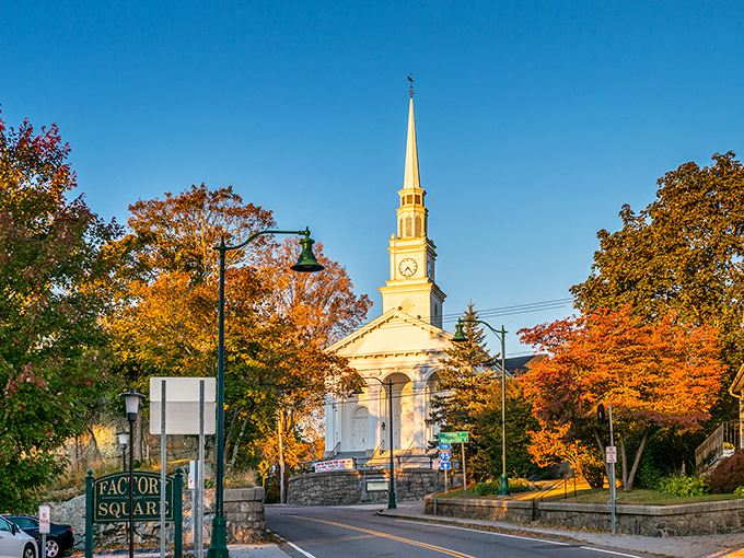 Fall foliage frames Mystic's iconic church, creating a Norman Rockwell painting come to life in this quintessential New England community.