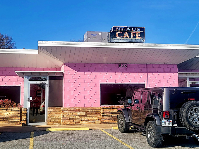 Neal's Cafe: The neon sign beckons like an old friend, while that pink facade stands out like your aunt's favorite flamingo lawn ornament.