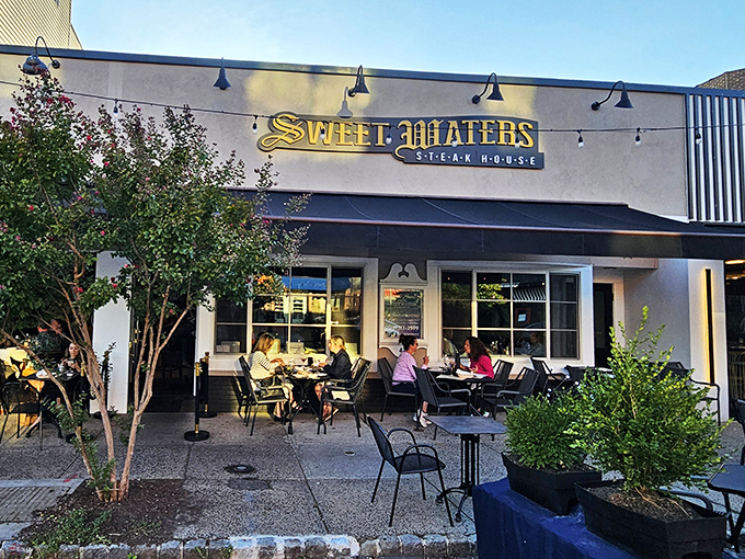 Outdoor dining at Sweet Waters feels like a secret garden party where the guest of honor is a perfectly cooked ribeye.