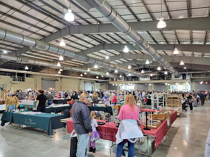 Treasure hunters navigate a sea of vendor tables at Tulsa Flea Market. It's like an archaeological dig, but with better lighting!