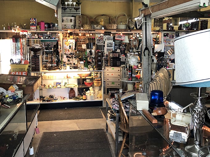 Vintage lamps stand guard over decades of collectibles. This booth could furnish a movie set or your next conversation piece.