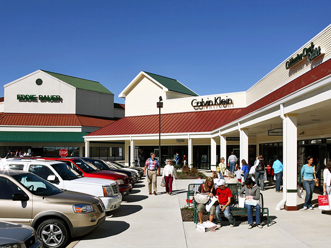 Calvin Klein and Eddie Bauer storefronts stand ready for action, while shoppers take a strategic rest before their next retail conquest.