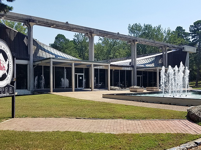 Approaching the museum feels like discovering a secret architectural gem. The sleek lines and water features create an oasis of cool in the Arkansas hills.