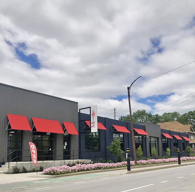 Those red awnings aren't just for show—they're like runway lights guiding bargain-hunters to a terminal where fashion gets a second chance at life.