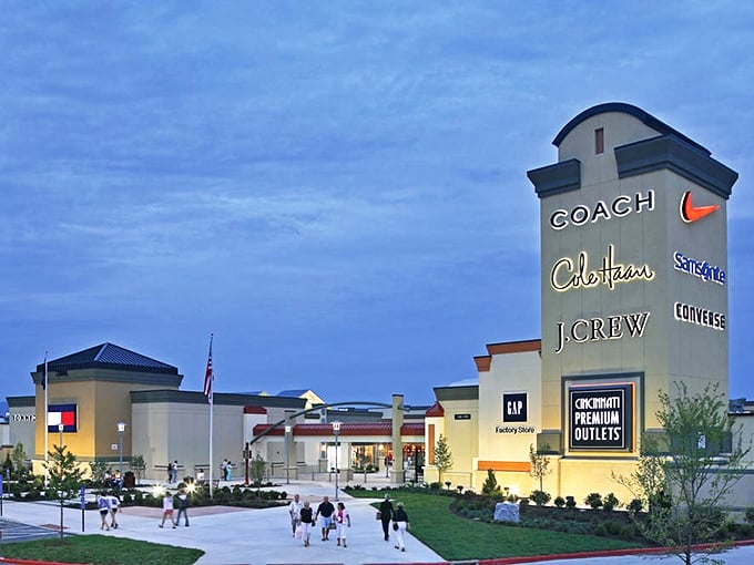 Twilight transforms this retail wonderland into a glowing beacon of bargains, with Coach, Cibotaux, and J.Crew standing ready for tomorrow's discount hunters.