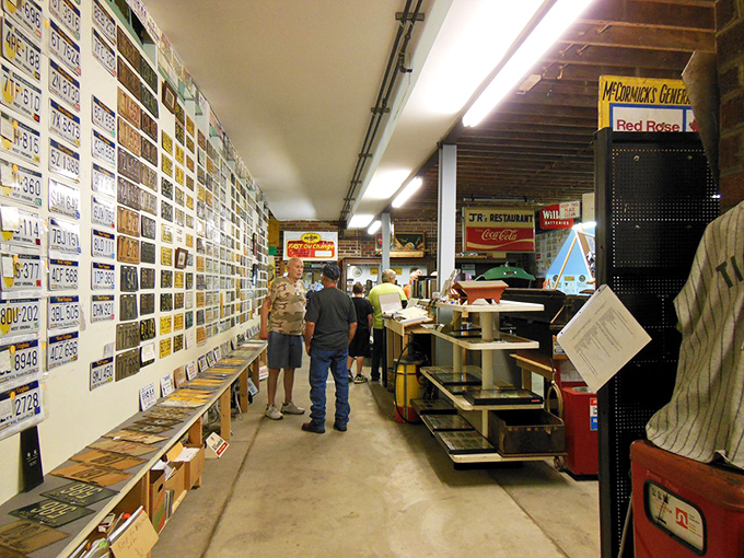 License plates line the walls like a patchwork quilt of American road trips, each one carrying stories of highways traveled and memories made.