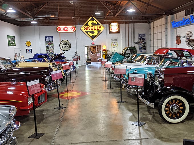 Inside, history gleams under perfect lighting. Vintage signs from Conoco, Skelly, and Phillips 66 watch over their mechanical children like proud parents.