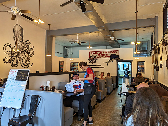 Inside, nautical charm meets cozy comfort. That octopus artwork isn't just decoration&mdash;it's foreshadowing the seafood magic about to happen on your plate.