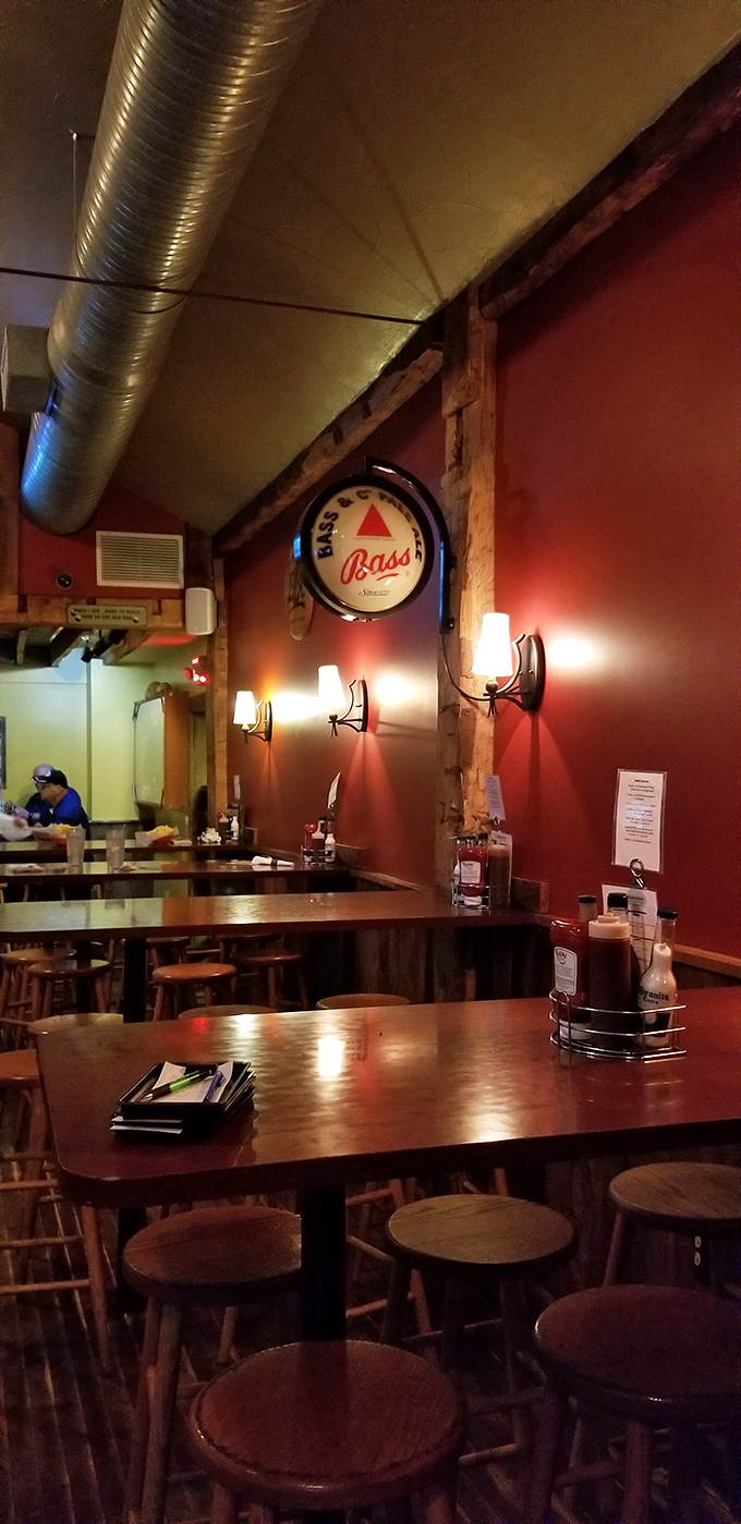 Where rustic meets revelry. Exposed beams, warm lighting, and that Bass sign watching over wooden tables like a guardian of good times.