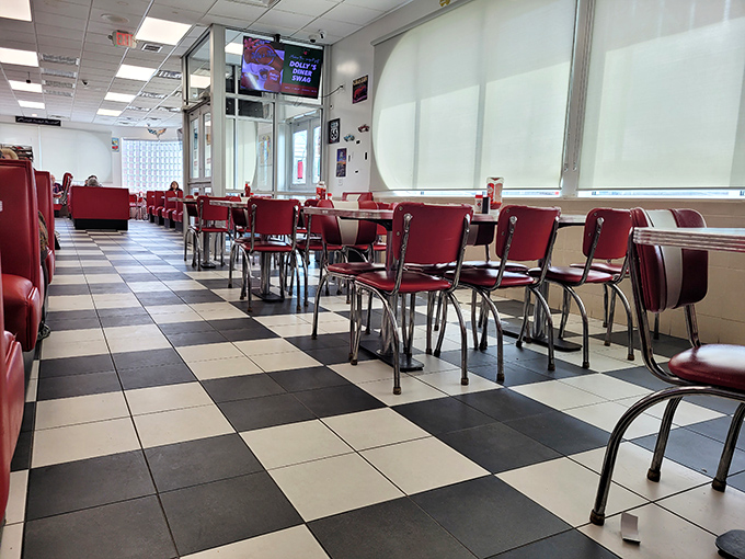 Black and white checkered floors meet cherry-red vinyl booths in this time capsule of Americana. The diner's interior feels like a warm hug from your favorite decade.