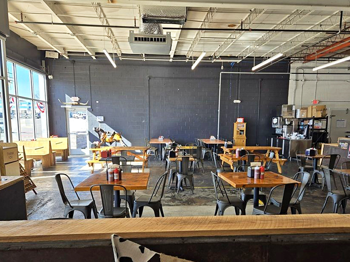 Industrial-chic meets barbecue simplicity with wooden tables, metal chairs, and an atmosphere that keeps the focus where it belongs&mdash;on the food.