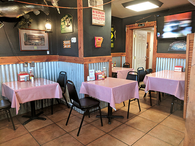 Classic red-checkered tablecloths and corrugated metal walls create that perfect "we care about the food, not the frills" atmosphere that promises authenticity.