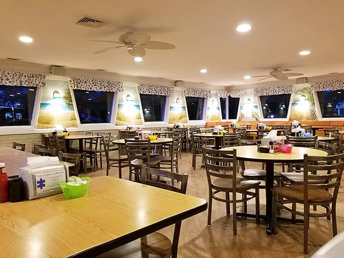 Inside, beach-themed lampshades cast a warm glow over wooden tables where breakfast dreams come true - notice the lack of sad faces anywhere.