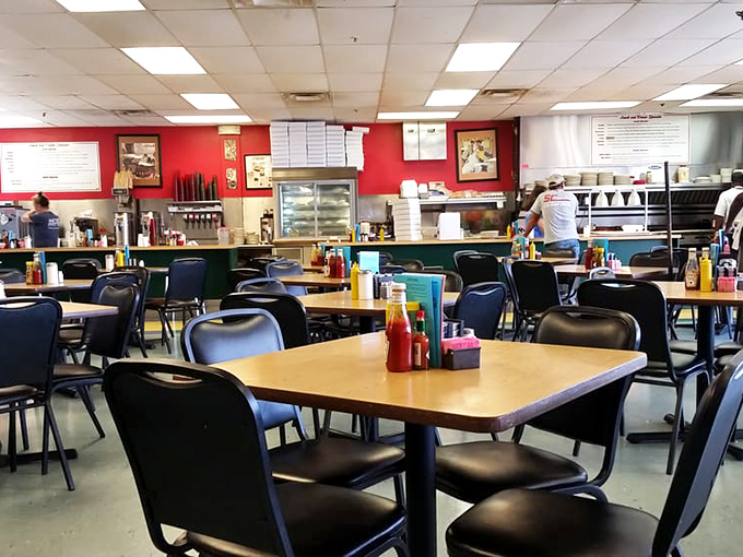 Simple tables, red walls, and zero pretension &ndash; this dining room isn't trying to impress Architectural Digest, just your taste buds. 