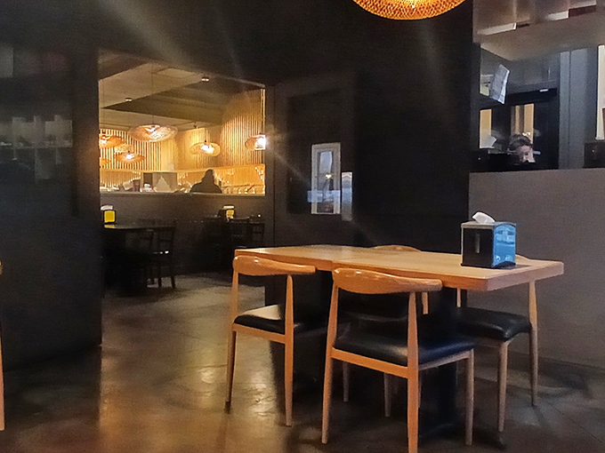 Modern wooden chairs and ambient lighting create the perfect setting for the serious business of multiple-plate dining.