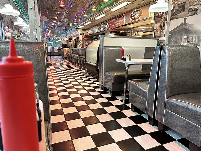 Classic black and white tiles lead you down a path of culinary nostalgia. That red ketchup bottle isn't just condiment&mdash;it's a promise of good things to come.