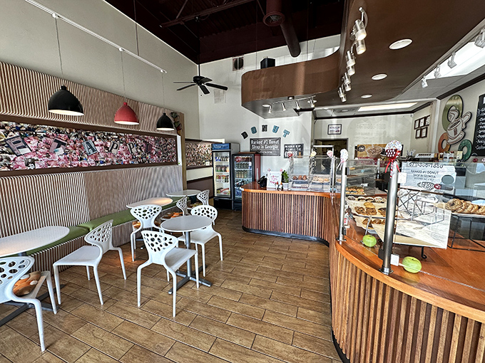 Inside awaits a modern donut sanctuary where the sacred ritual of coffee and fried dough unfolds amid warm wood accents and contemporary design.