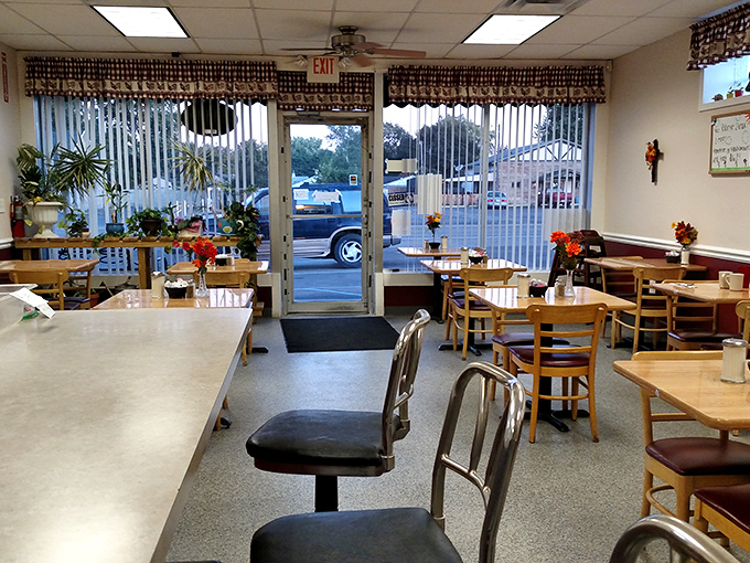 Inside, time slows down as checkered curtains frame potted plants and wooden tables where countless conversations have unfolded over steaming coffee cups.