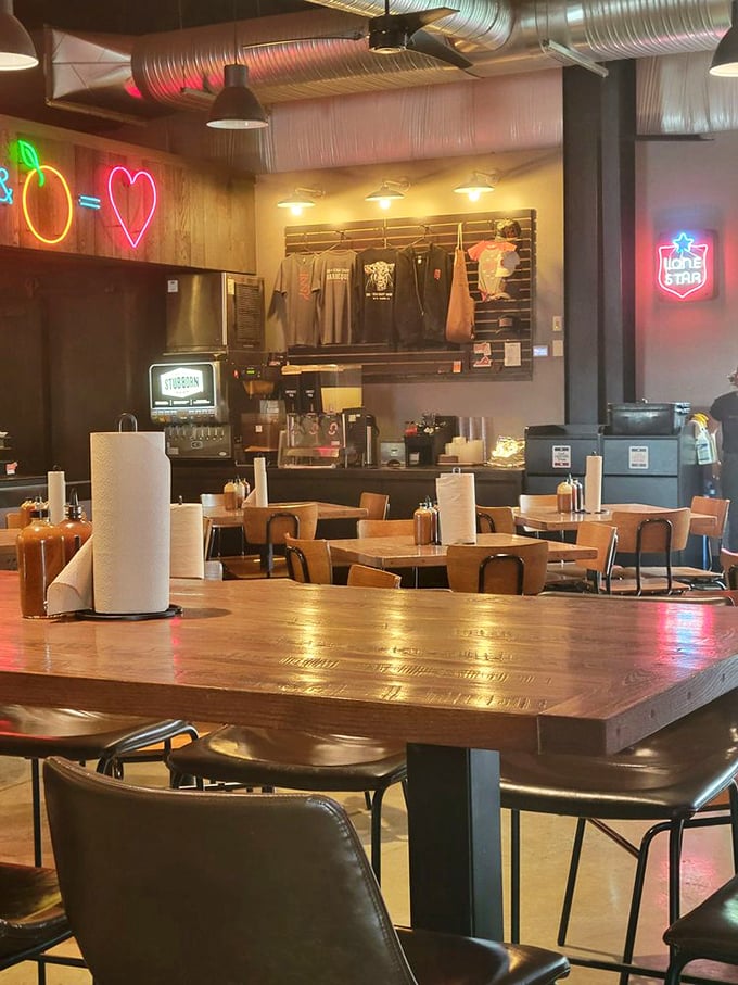Neon lights and rustic wood create the perfect atmosphere for meat meditation. The heart on the wall? That's where your love affair with brisket begins.