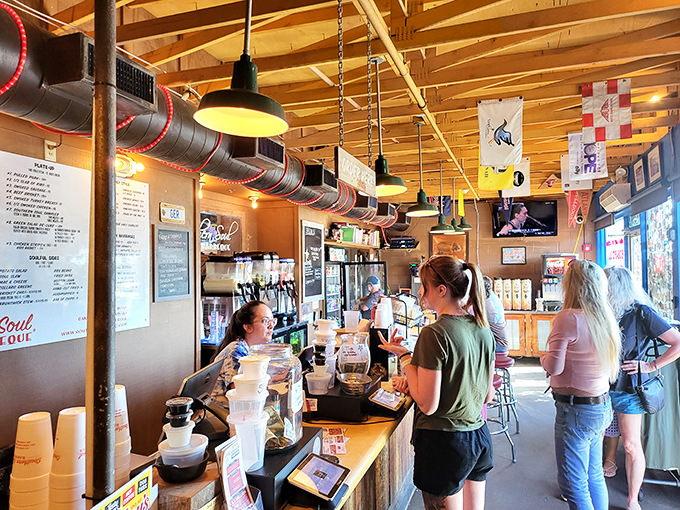 Inside, rustic charm meets BBQ seriousness. Wood paneling, exposed beams, and that heavenly aroma create the perfect backdrop for meat-induced euphoria. 