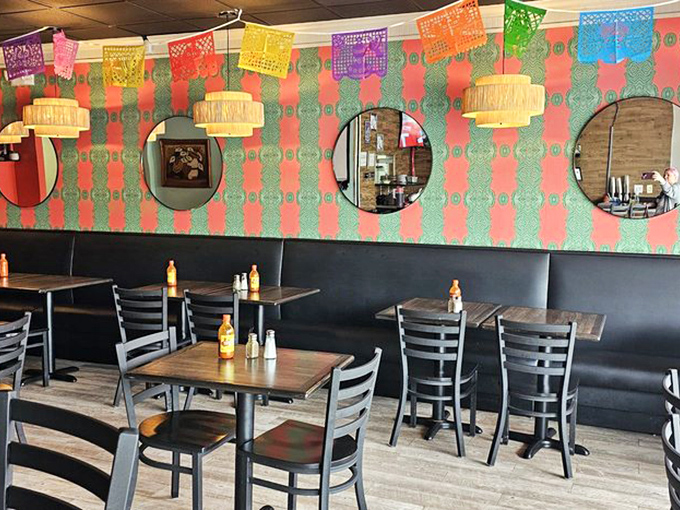 Inside, colorful papel picado banners dance overhead while cozy wooden tables invite you to settle in for a flavor fiesta.