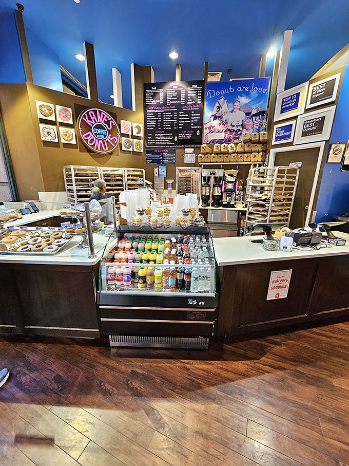 The counter at Kane's is where dreams come true. Blue ceiling above, wooden floors below, and in between? Pure donut paradise.