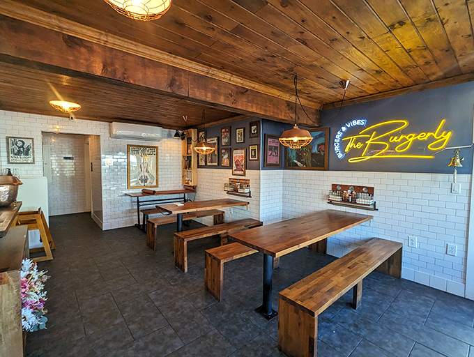 Rustic wooden tables and benches invite communal dining under warm pendant lights&mdash;burger paradise with a side of conversation. 