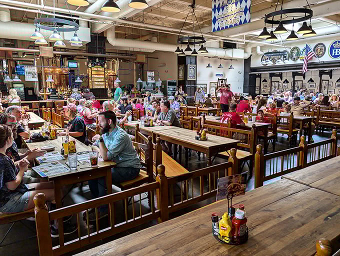 Communal tables filled with happy diners create that magical atmosphere where strangers become friends over steins and schnitzel.