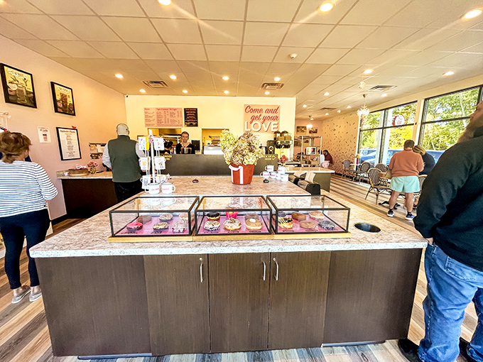 Inside awaits donut nirvana – sleek display cases, marble countertops, and that pink neon sign promising sweet revelations.