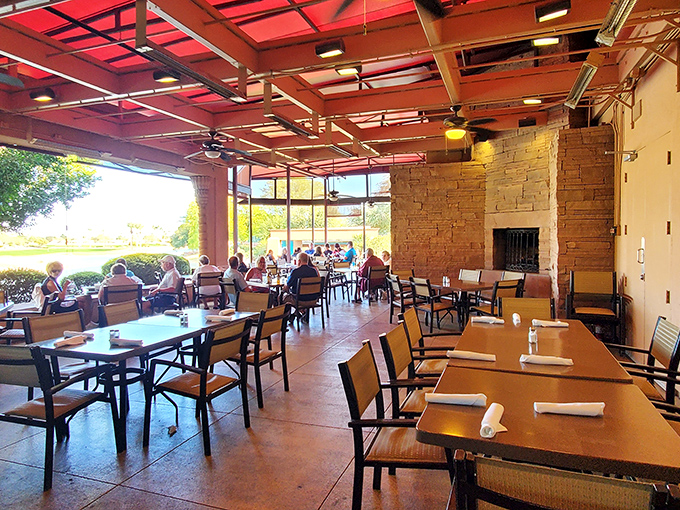 The covered patio offers the perfect blend of indoor comfort and Arizona sunshine, with stone accents that whisper "stay awhile" to every diner.
