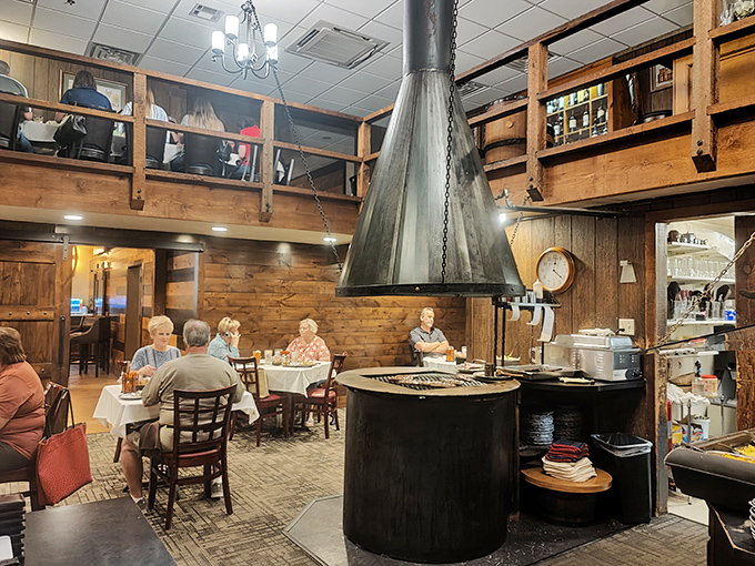Dinner and a show! The central conical hood isn't just for looks—it's where meat magic happens while diners enjoy the rustic, multi-level charm.