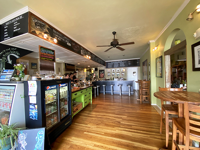 Warm wooden floors and playful green accents create an atmosphere so inviting you'll want to move in&mdash;or at least stay until dinner.