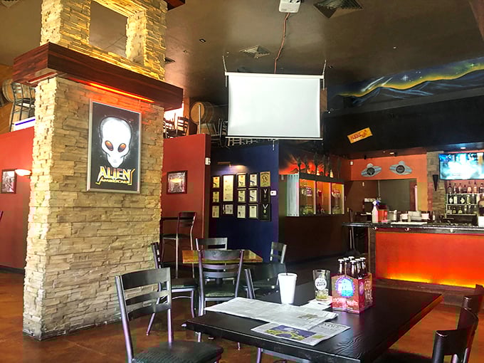 Step inside and you're greeted by stone columns, mood lighting, and alien imagery &ndash; like a cozy spacecraft that happens to serve excellent food and drink.