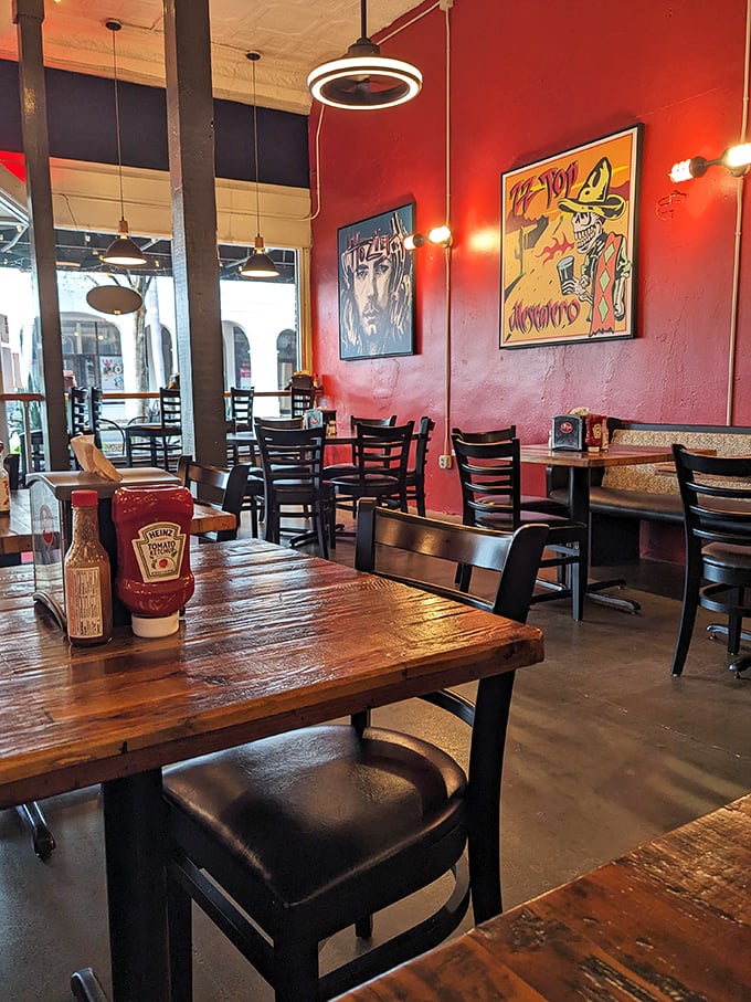 Vibrant red walls adorned with eclectic artwork create the perfect backdrop for burger bliss. This isn't just eating; it's an experience.