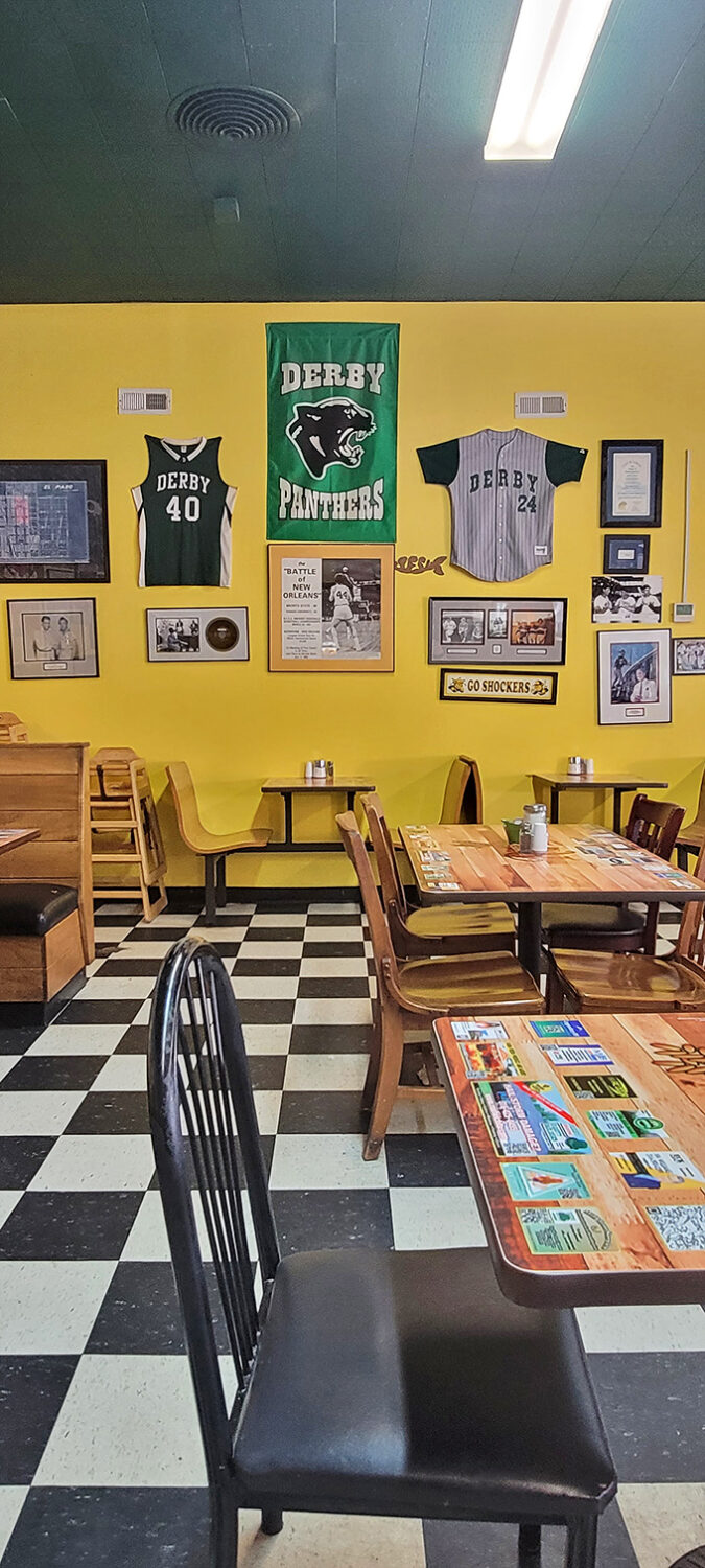 Derby Panthers pride covers these yellow walls. Local sports memorabilia transforms a simple diner into a community living room.