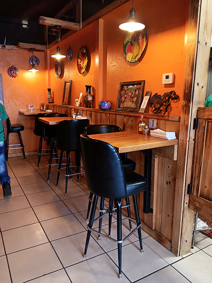 Warm orange walls adorned with colorful Mexican artwork create an atmosphere that transports you south of the border without the passport hassle.