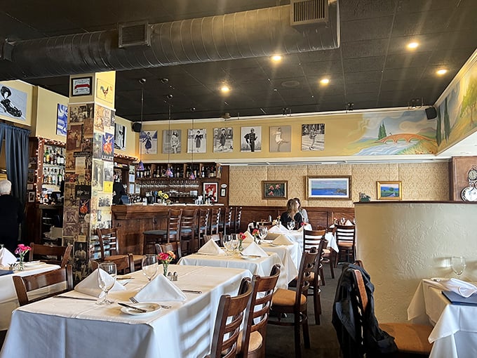 Inside, cream walls adorned with French artwork and crisp white tablecloths create that perfect balance of casual elegance where memories are made between courses.