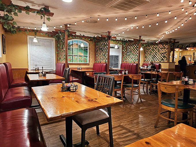 Red vinyl booths, wooden tables, and string lights create that classic Italian-American atmosphere where memories are made between bites of pasta.