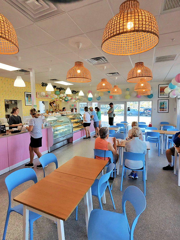 Inside, wicker pendant lights and blue chairs create a coastal-meets-Provence vibe that makes you want to linger long after your croissant is just a memory.