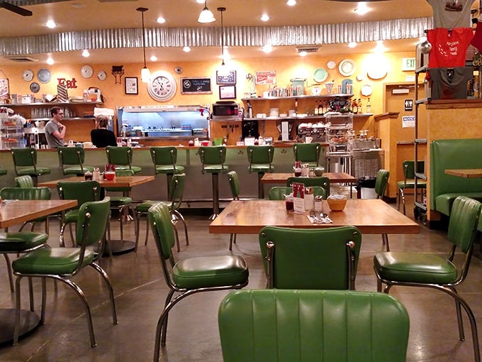 Retro mint-green chairs and warm yellow walls create the perfect backdrop for morning conversations. Comfort begins before the food arrives.