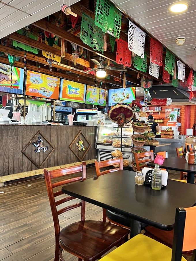 Colorful benches outside invite you to take a moment before diving into taco heaven. The orange building stands out like a happy culinary exclamation point.